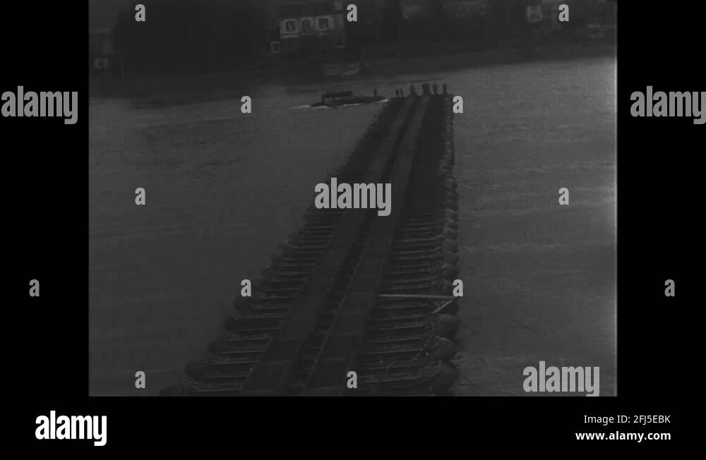 Engineers build steel treadway pontoon bridge over the Rhine - 1945 ...