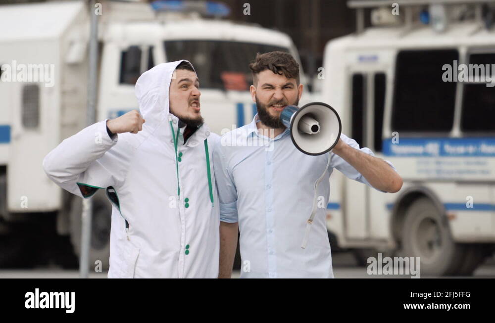 Crazy and angry people scream in loudspeaker. Riots in the city of 4k ...