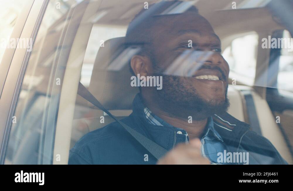 Handsome Successful Black Man Rides on a Passenger Seat of a Car, He's ...