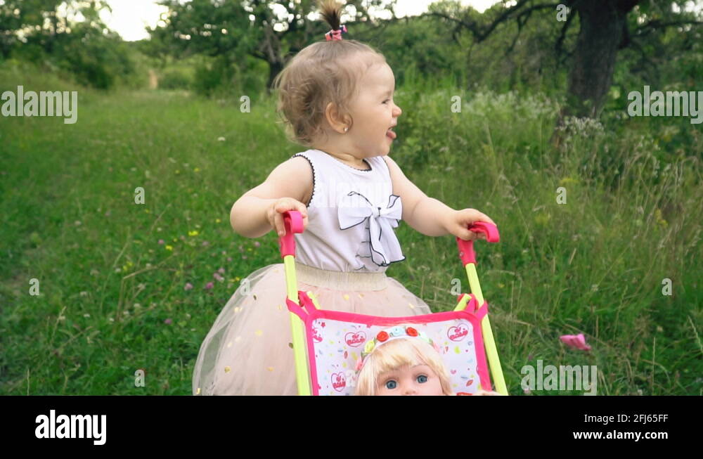little girl with a stroller Stock Video Footage - Alamy
