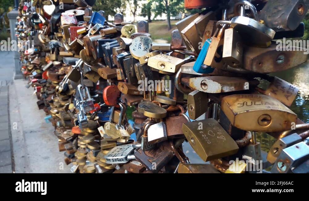 Full bridge of love locks in downtown of Riga. Enternity symbols ...