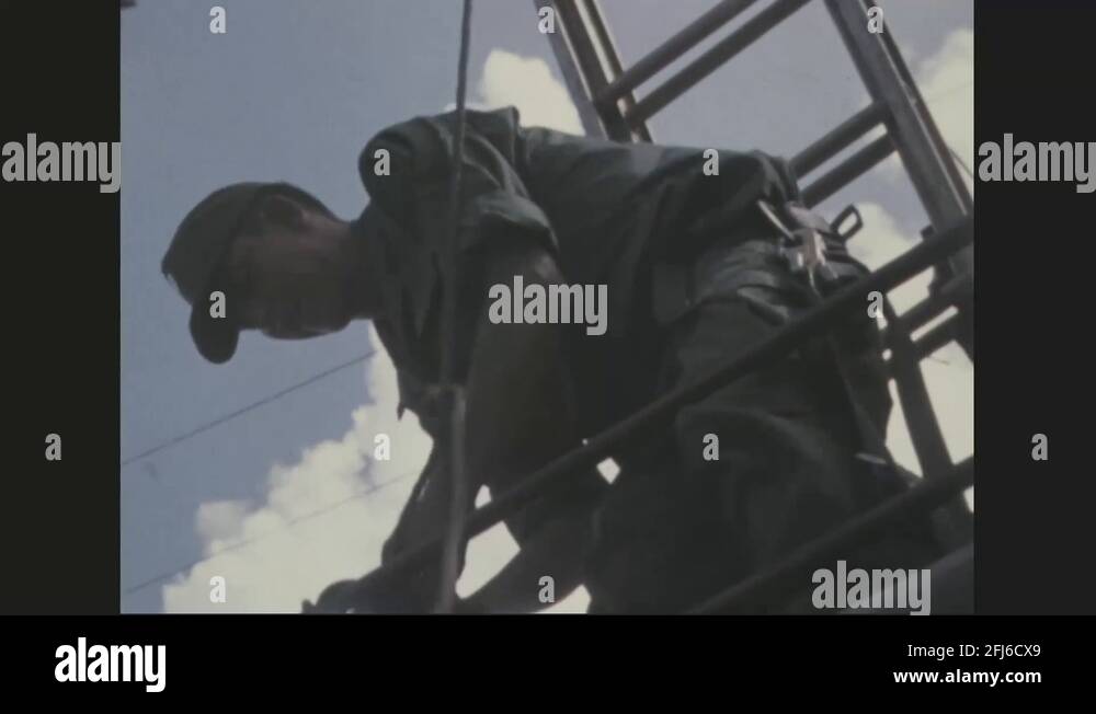 Soldier atop ladder prepares to install terminal box on the pole - 1961 ...
