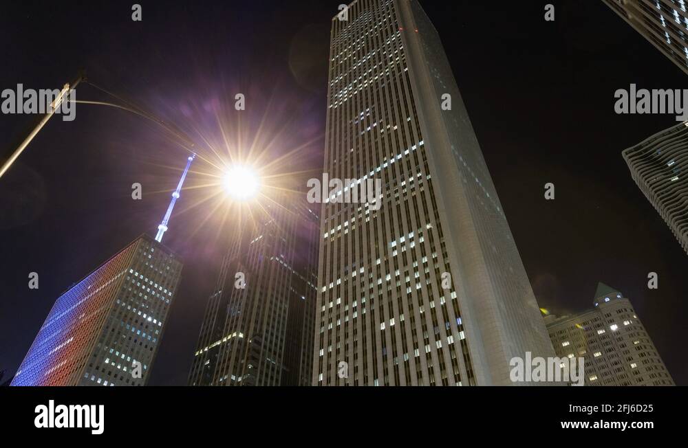 Night Timelapse hyperlapse of Chicago skyscraper with street light pole ...
