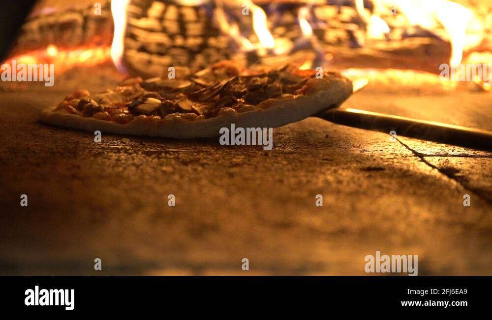 Moving pizza while cooking it in a wood fired oven Stock Video Footage ...