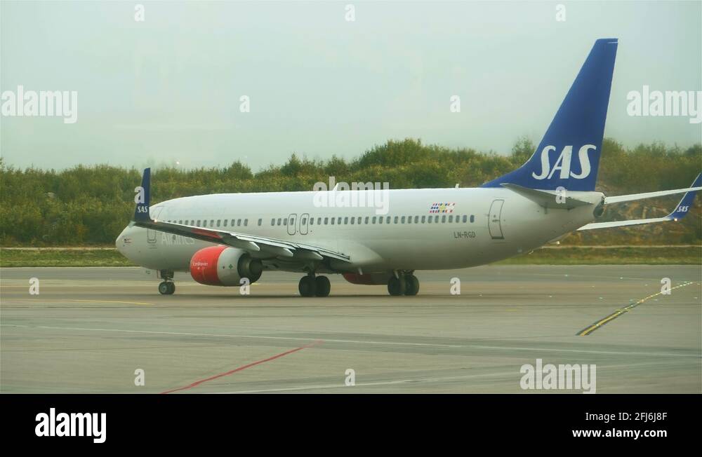 Passenger mid size aircraft of scandinavian airlines taking a turn with ...