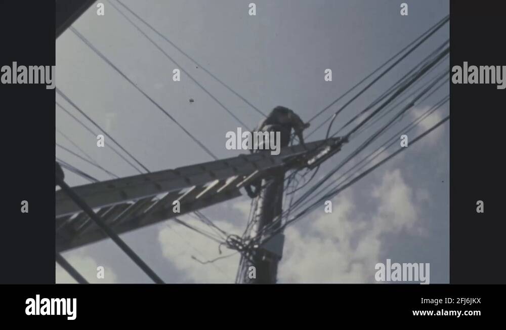 Soldier atop ladder prepares to install terminal box on the pole - 1961 ...