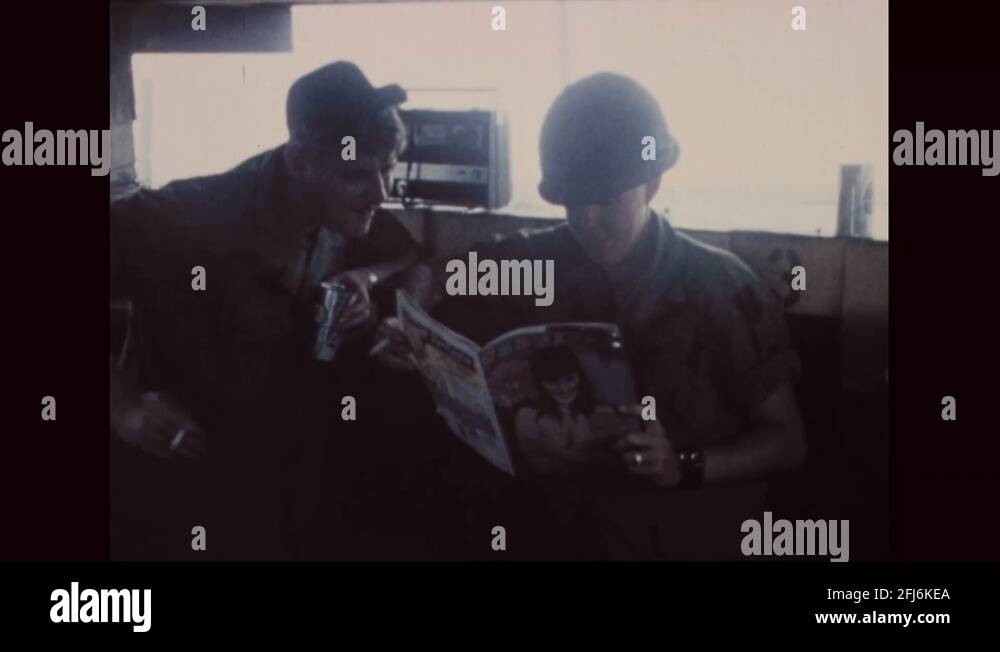 Two soldiers read a magazine in bunker at 1st Air Cavalry Division Area ...