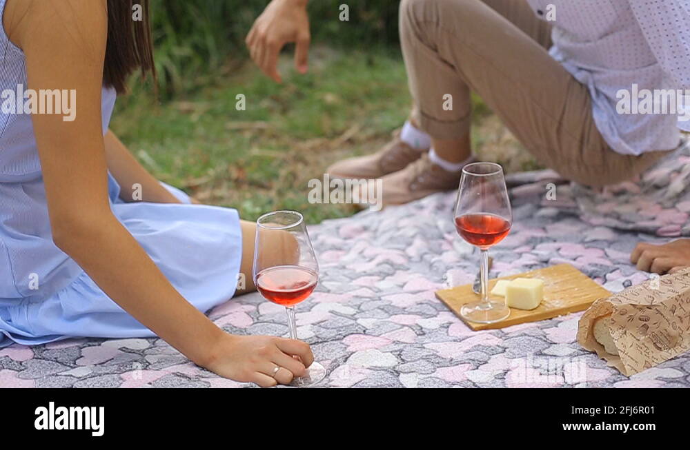 romantic picnic of a young couple in love in the forest near the lake ...