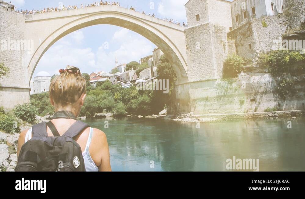 Mostar Stari most bridge woman taking photo flare Stock Video Footage ...
