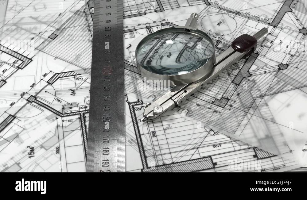 Blueprints - architectural drawings, compasses, a magnifying glass, a ...