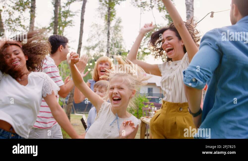 Family and Friends Dancing together at the Garden Party Celebration ...
