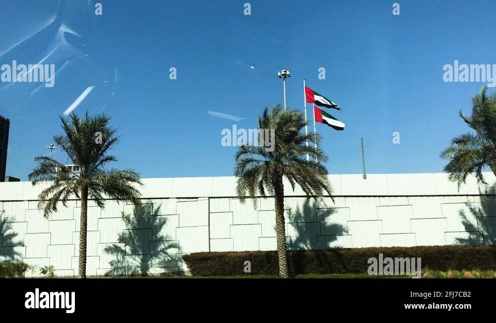 Driving inside a car in Dubai downtown. Video with motion. UAE flags ...