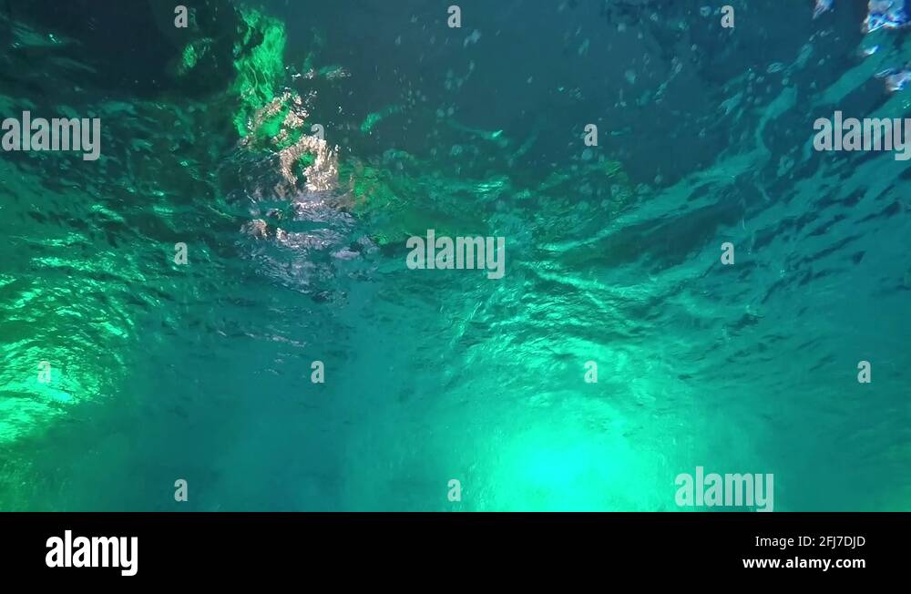 Bubbles are rising to the water surface of the swimming pool ...