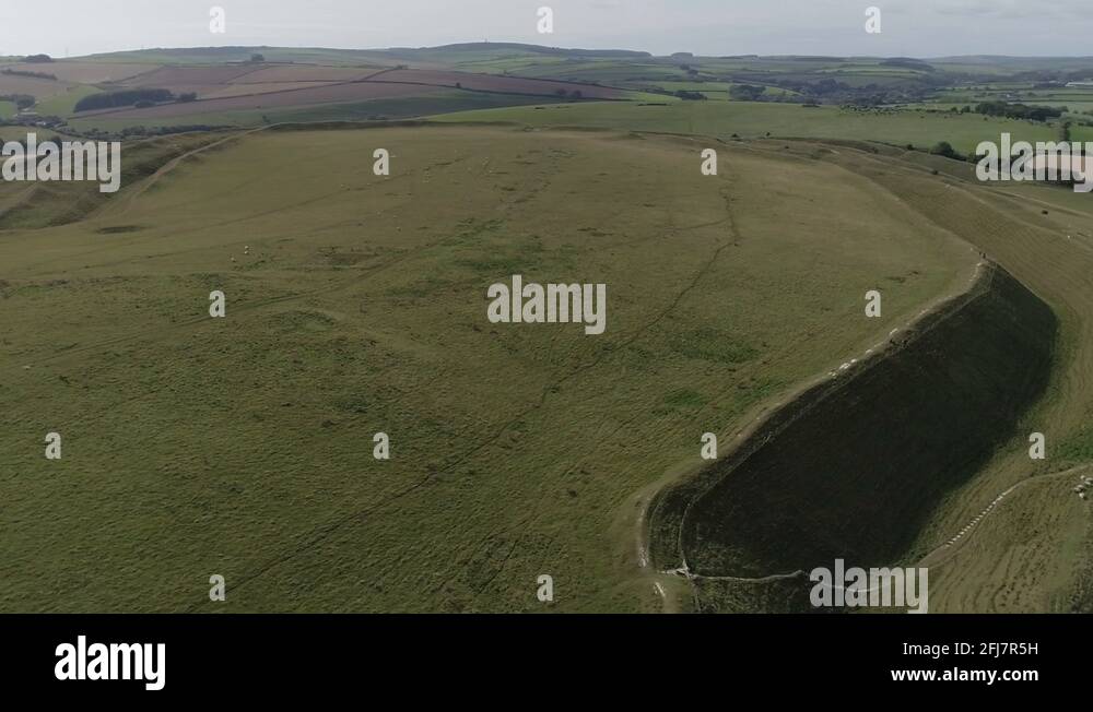 Rotating aerial around the famous Iron-age hill fort of Maiden Castle ...