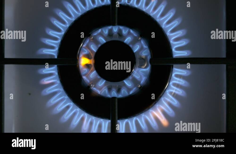 Gas stove burner top view. Burning blue flames of gas in the dark Stock ...