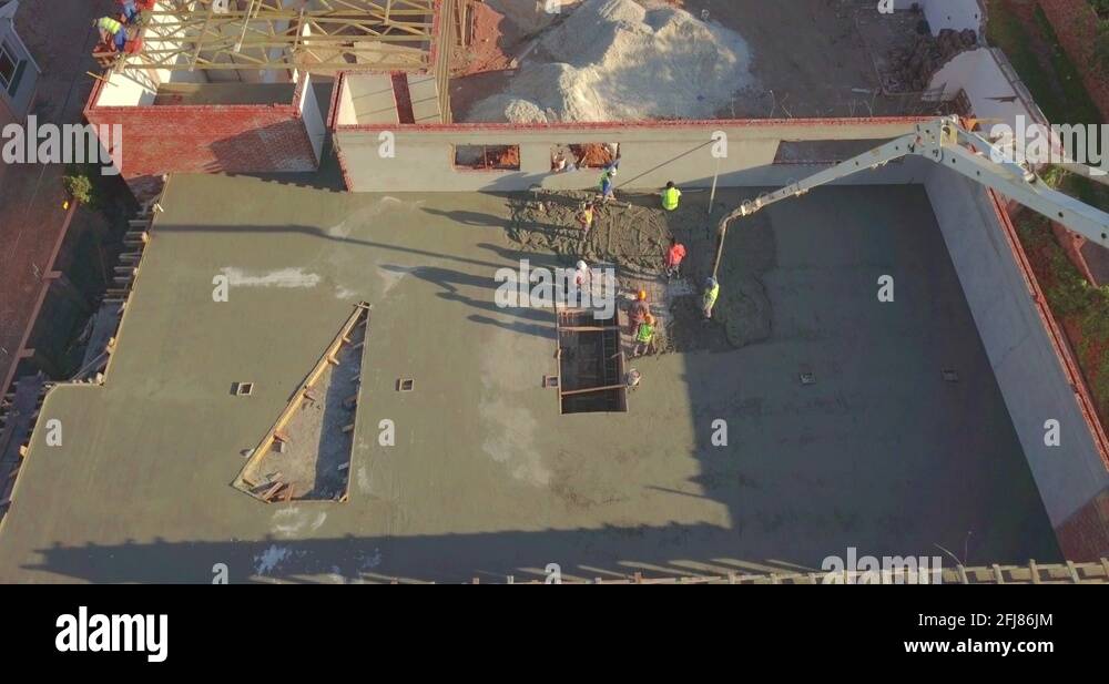 Construction workers working on the first floor of a new building ...
