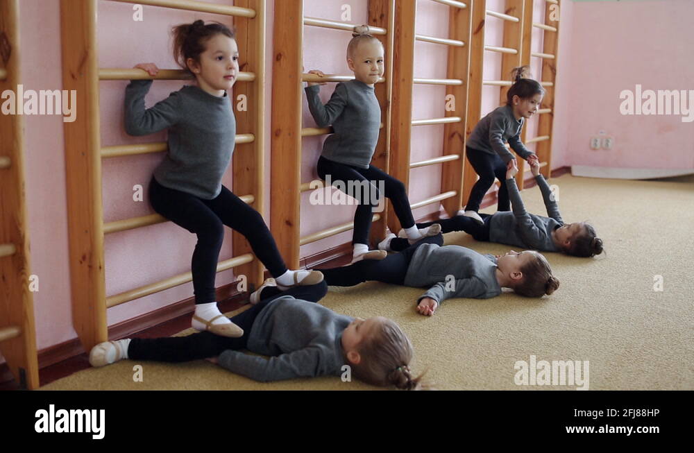 Little girls gymnasts warm up in the gym. Exercises in rhythmic ...