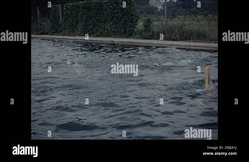 1940s: UNITED STATES: synchronised swimming in outdoor pool. Girls swim ...