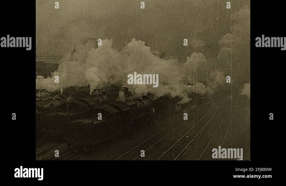 1930s: UNITED STATES: pollution in city. Smoke from steam engines ...