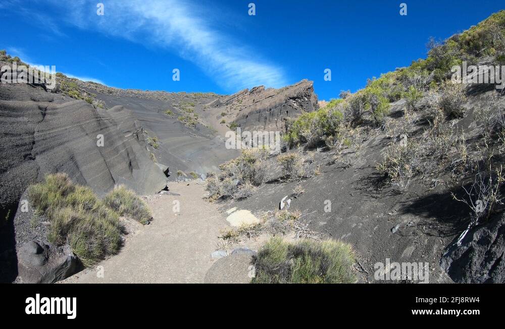 Walking inside volcano malacara grey debris, dry river of vocanic ...