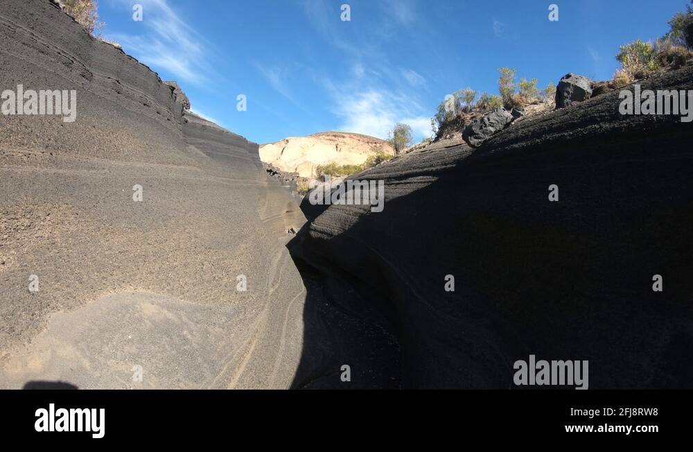 Walking inside volcano malacara grey debris, dry river of vocanic ...