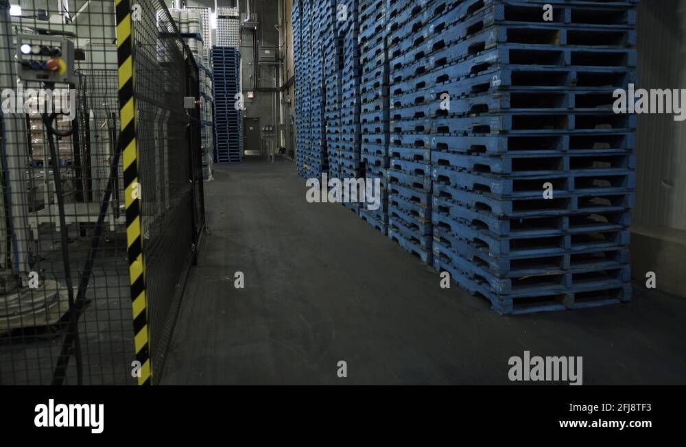 Tilt up stack of blue palettes in a factory Stock Video Footage - Alamy