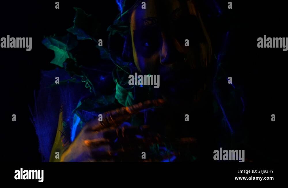 Creepy monster with long fingers twitches his head and stares Stock ...