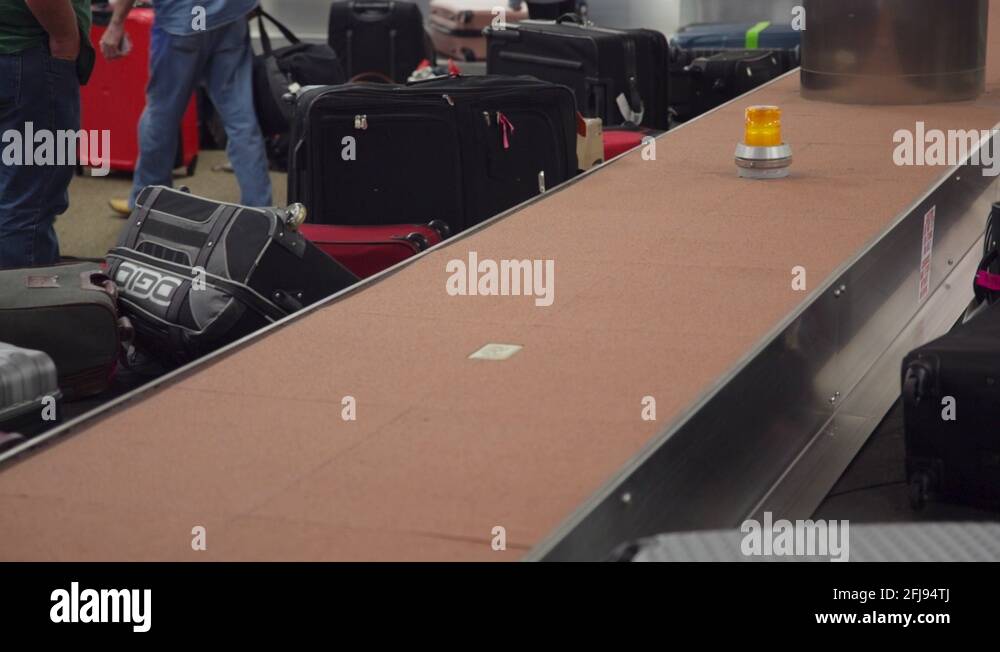 Baggage travels around a carousel at an airport baggage claim Stock ...