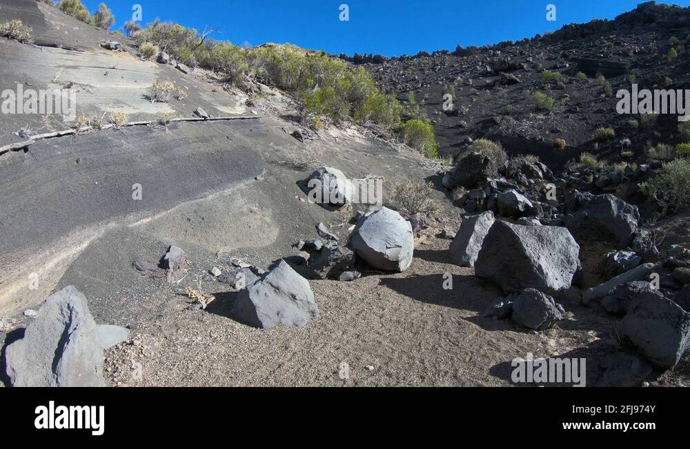 Walking inside volcano malacara grey debris, dry river of vocanic ...