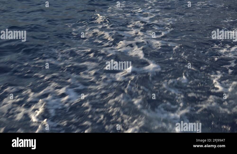 Sea surface of the water, view from a moving boat. The boat sails on ...