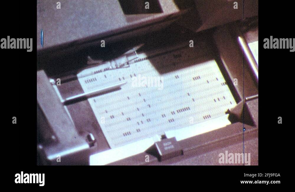 1960s: Punch cards travel through a machine. Man hands stack of punch ...