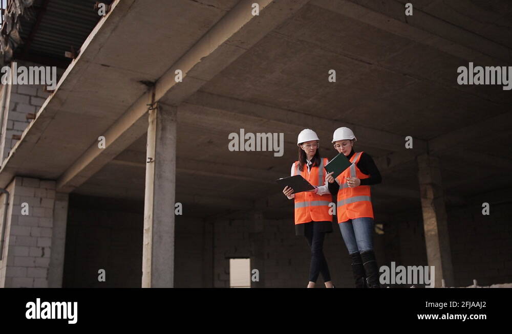 Two women inspectors to inspect and check the construction plan at the ...