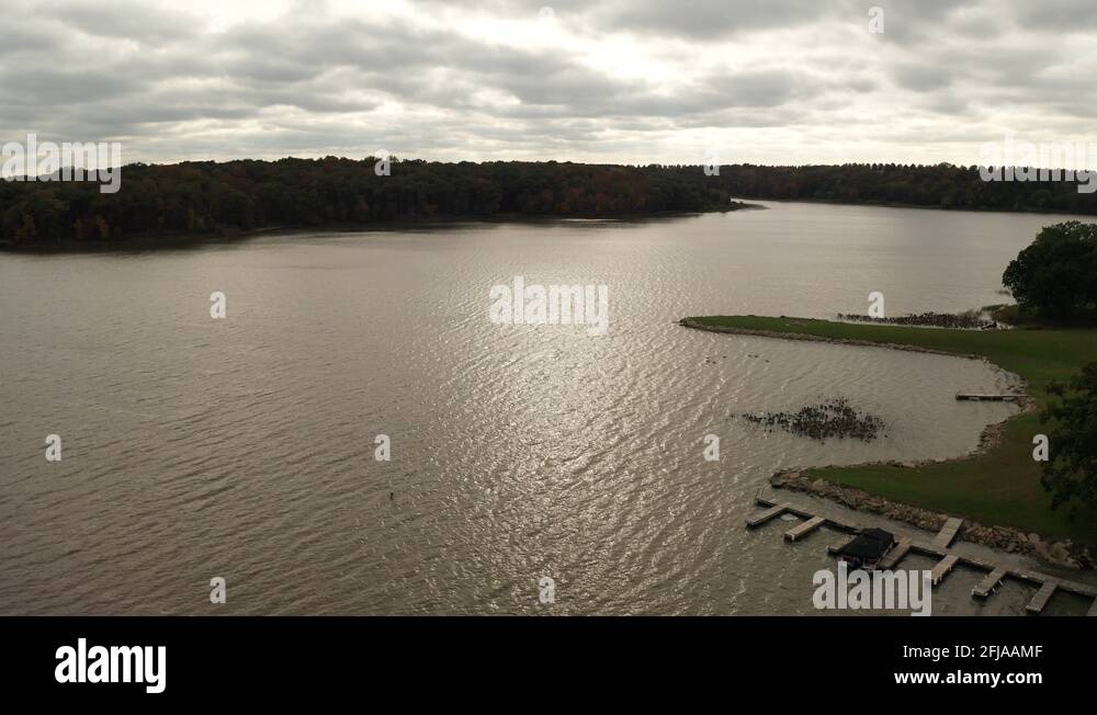 An Aerial view of a restless lake as the camera descends to the docks ...