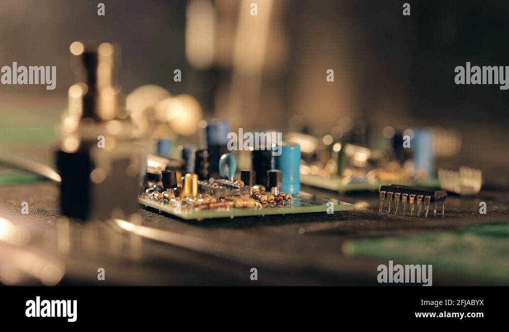 Assembling a circuit board. Putting microcircuit on PCB with tweezers ...