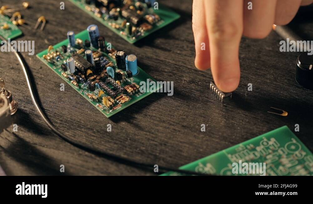 Assembling a circuit board. Putting microchip on PCB with fingers Stock ...