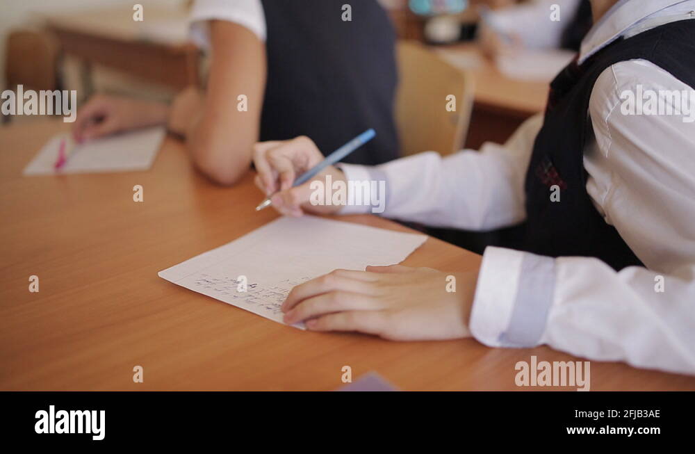 college students in school uniform write certification work. test of ...