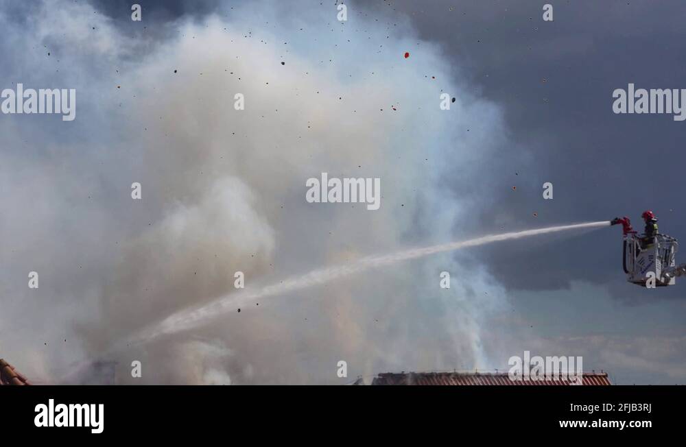 Fireman fights house fire in bucket truck flying embers cinemagraph ...
