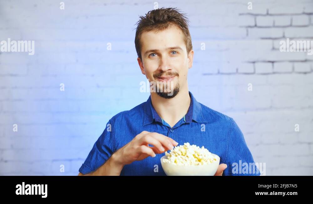 Person eating popcorn while smiling meme 4K Stock Video Footage - Alamy