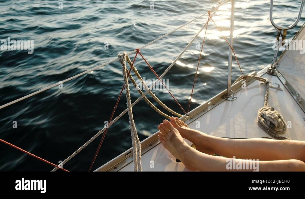 Female legs feet on the sailing yacht closeup in the open sea Stock ...