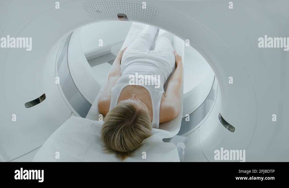 Female Patient Lying on a CT or MRI Scan, Bed is Moving inside Machine ...