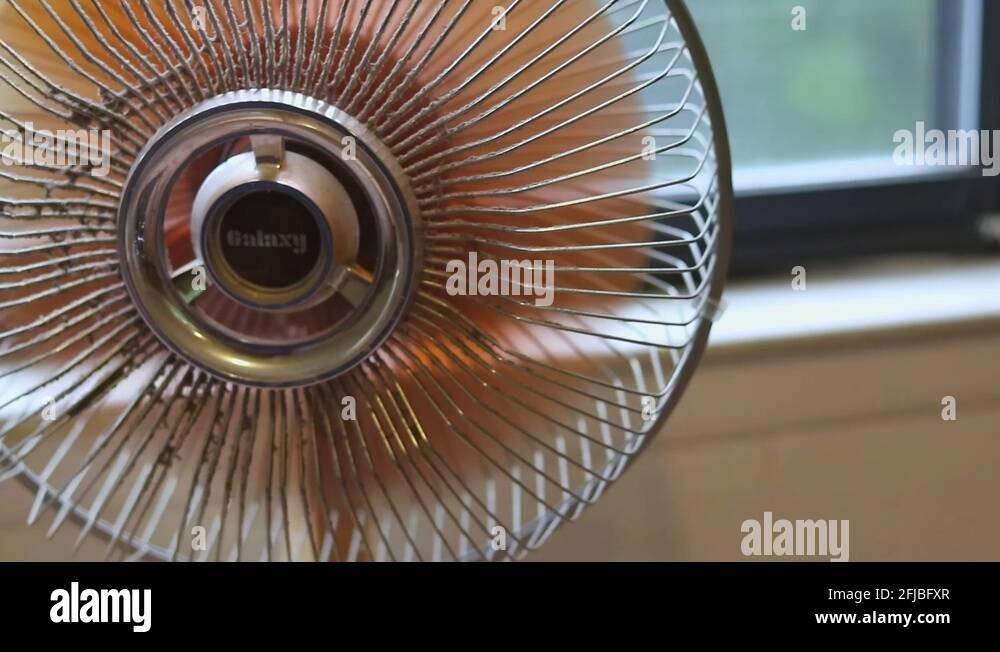 Oldschool fan rotates from left to right and back, steady close up with ...