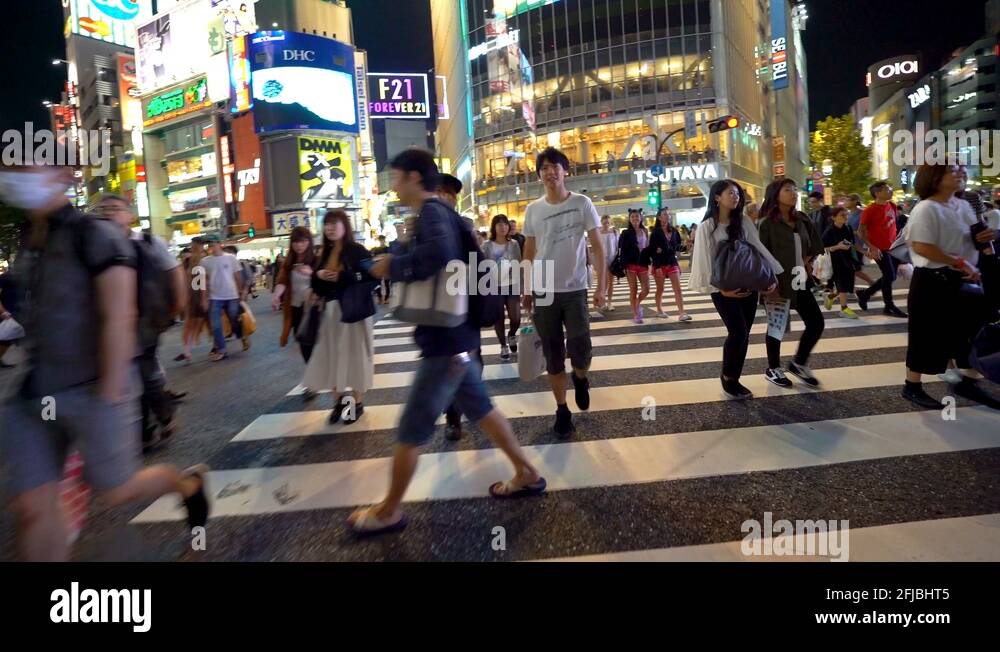 People cross the famous intersection in Shibuya, Tokyo, Japan Stock ...
