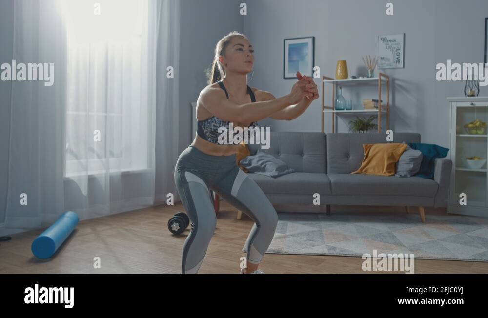 Strong and Fit Beautiful Busty Girl in an Athletic Top is Doing Squat ...