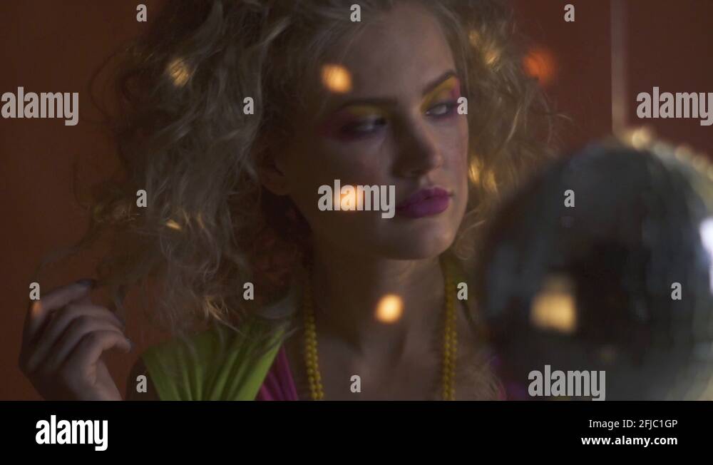 Retro disco atmosphere, disco ball and lights, young blonde woman in ...