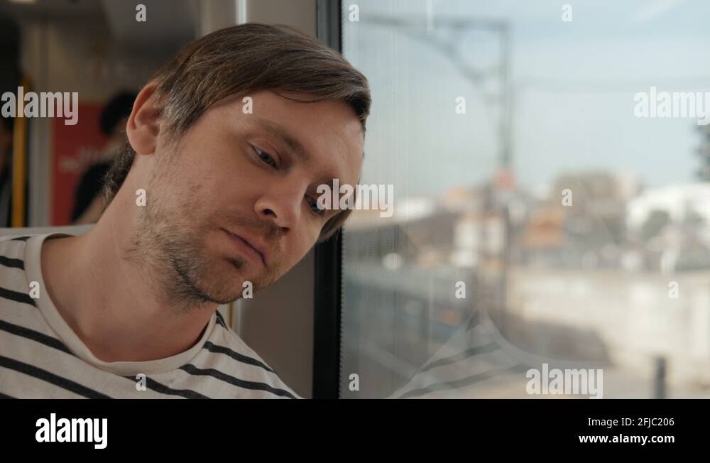 man sleeping in a underground Metro subway train. Tired worker student ...