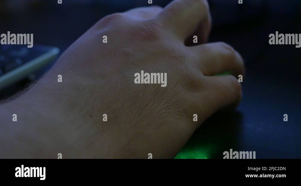 Men's hand using mouse in dark. Gamer playing at night. Close up Stock ...
