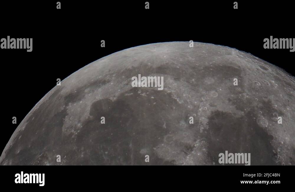 a super telephoto video of The giant full Moon passing through the ...