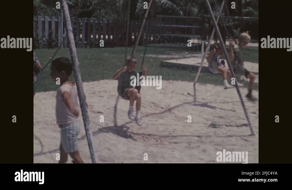 American children play on swings in playgrounds - 1972 Stock Video ...