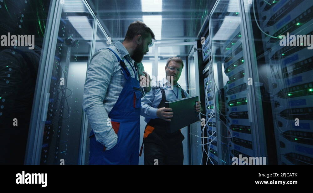 Two men performing maintenance in a data center Stock Video Footage - Alamy