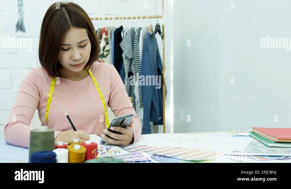 Female designer drawing for her dress design project at workplace Stock ...